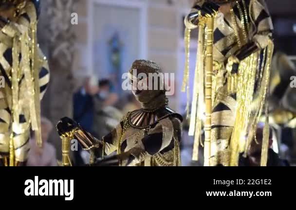 Captivating Carnival Parade: Golden Masquerade Costumes Illuminated by ...