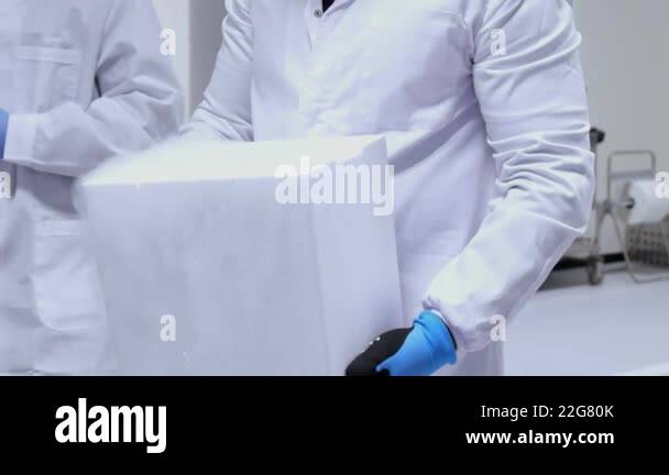 closeup Laboratory technician carefully moves a block of dry ice ...