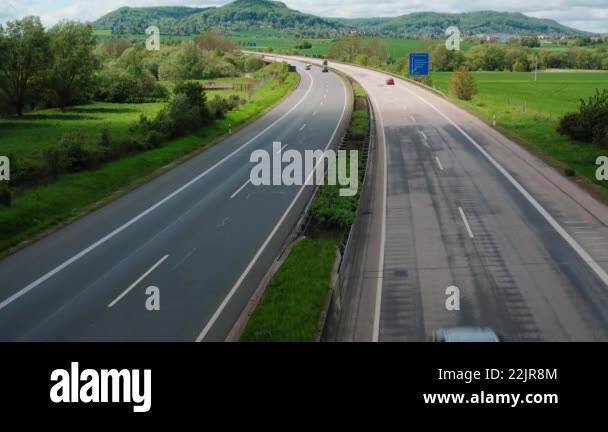 Transport traffic on two-way road on a sunny day. A two-lane road with ...