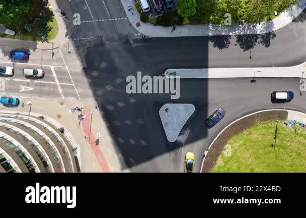 Aerial view of a city intersection with cars and a triangular traffic ...