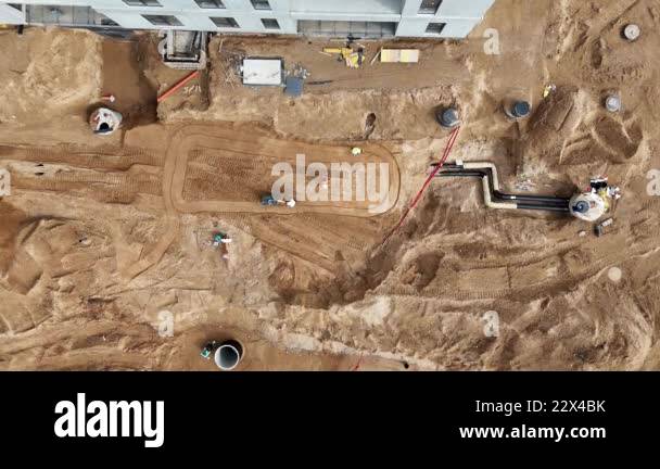Aerial view of a construction site with workers and equipment, showing ...