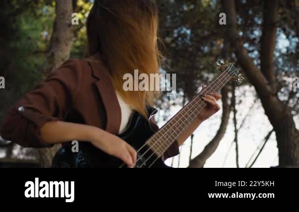 Girl playing bass guitar in the nature near the beach Stock Video ...