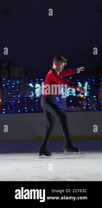 Vertical video, dancing on ice, man pro gymnast performs a trick on ice ...