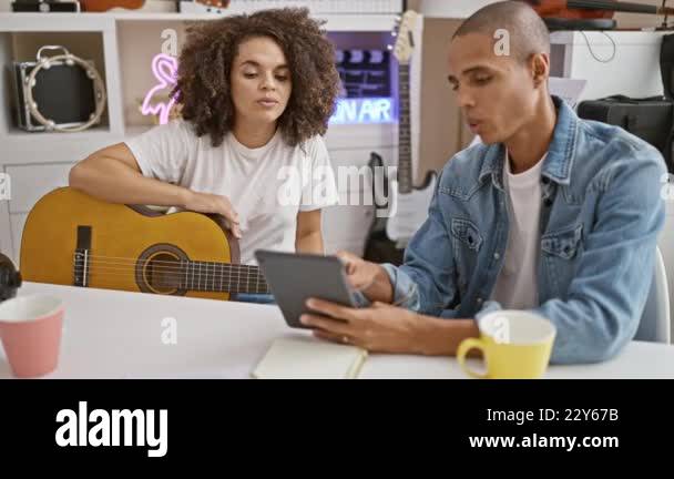 Artists and musicians playing classic guitar tunes via touchpad in a ...