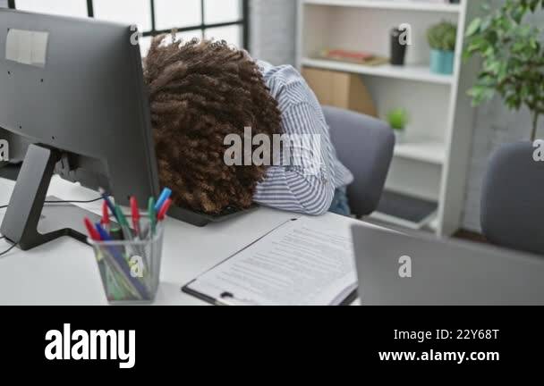 Two exhausted workers in an office, man and woman falling asleep on ...