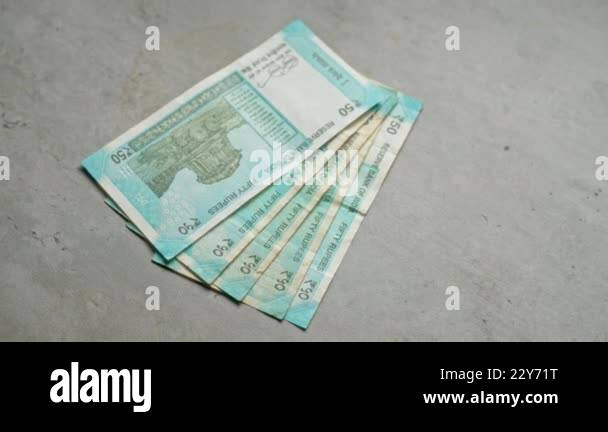 Indian banknotes featuring fifty rupees on concrete surface displaying ...