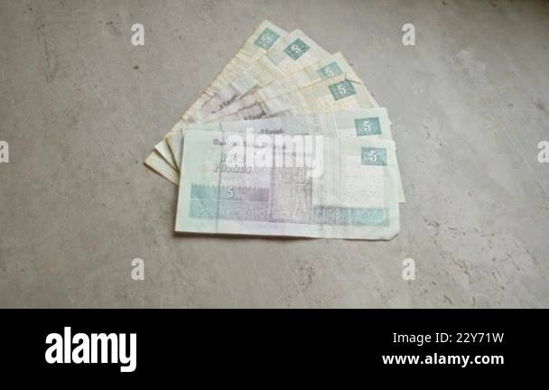 Egyptian five pound banknotes fanned out on a concrete surface ...