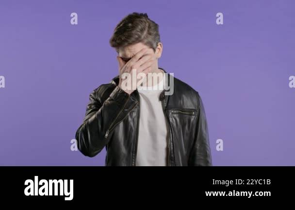 Worried man doing facepalm gesture, covering face with hands, like no ...