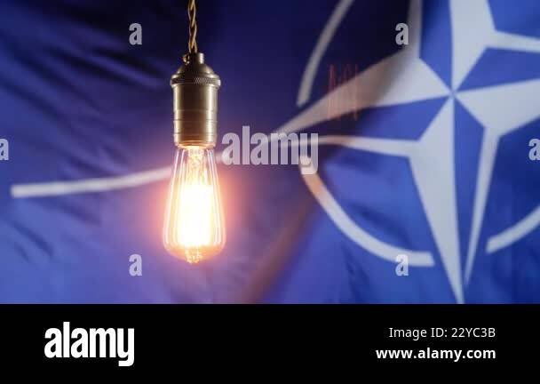 Edison light bulb on NATO OTAN flag background. Creative idea ...