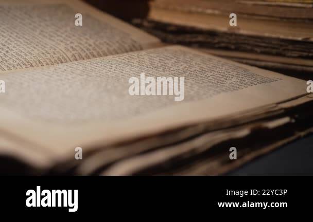 Opened saved old paper book with ancient writings. Religious literature ...