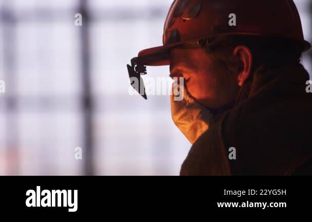 An industrious worker is wholly focused on the task at hand, showcasing ...