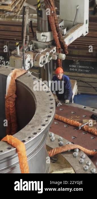 An operator is currently engaged in working on a large industrial ...