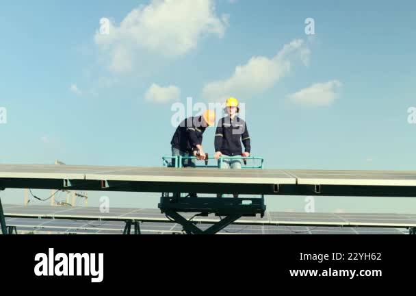 Repair team leads male and female technicians onto lifts inspects solar ...