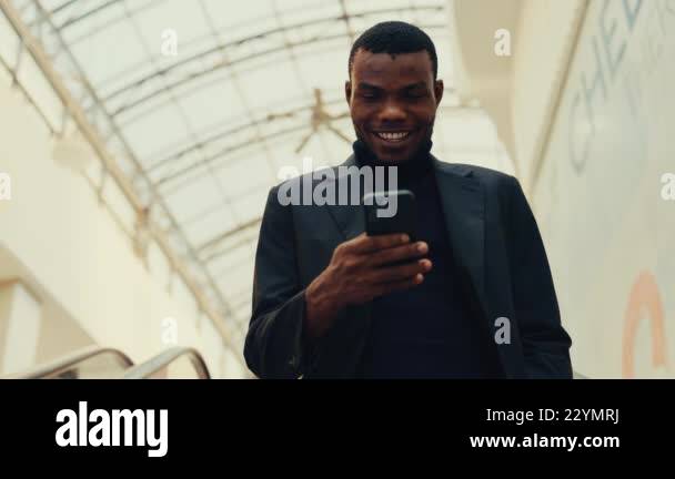 Portrait of African American businessman with toothy smile holding ...