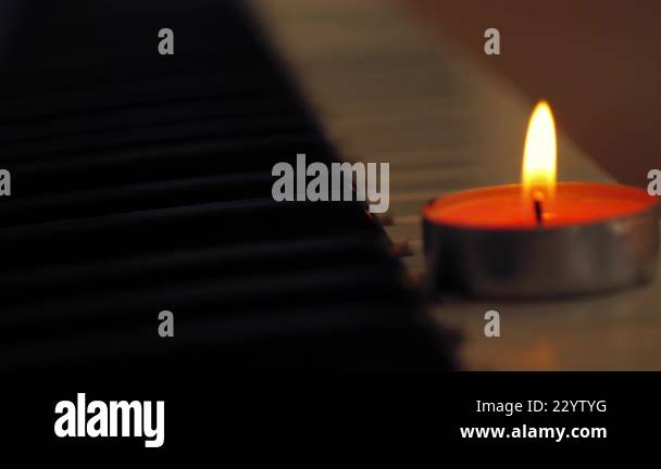 Candles with piano organ musical instrument background close up zoom ...