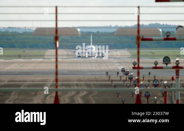 Commercial aircraft picks up speed and takes off, view from the end of ...