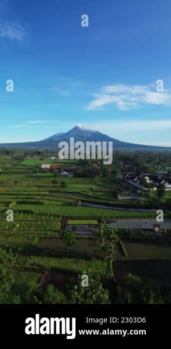 Aerial portrait footage of the beautiful panorama of Mount Merapi on a ...