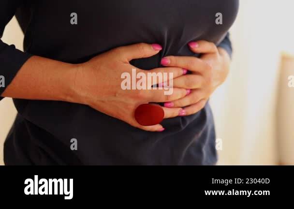 A woman places her hands on her stomach, performing external techniques ...