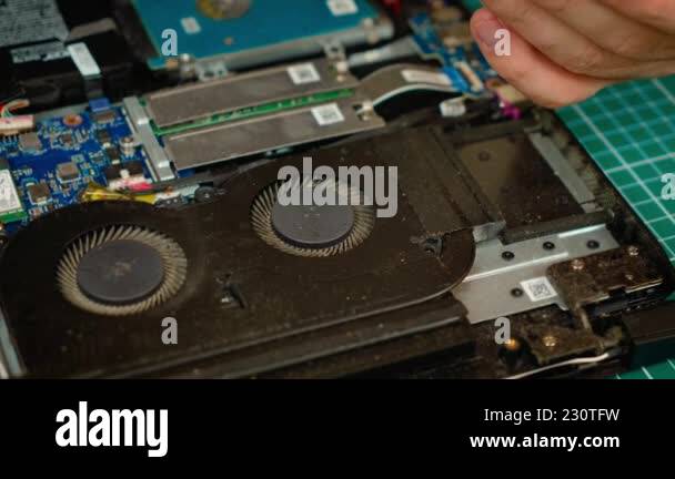 Laptop cooling system with dual fans covered in dust. Internal hardware ...