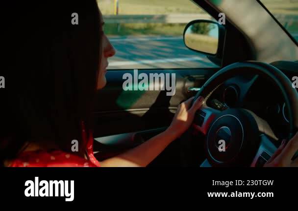 Woman confidently holding steering wheel while driving car, expression ...