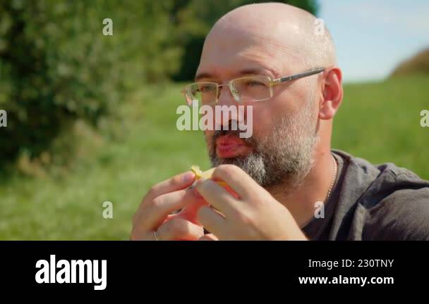 Bearded man eating sour lemon and reacting with puckered face. Male ...