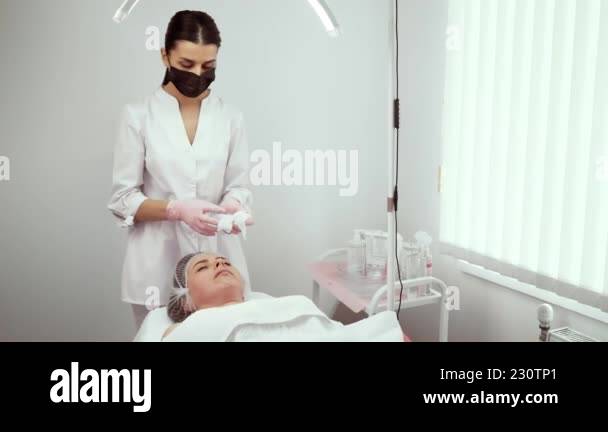Skincare specialist working in dermatology office preparing for facial ...