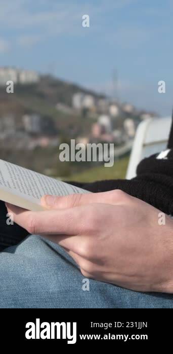 Image of lonely man reading novel on white bench in sunny day ...