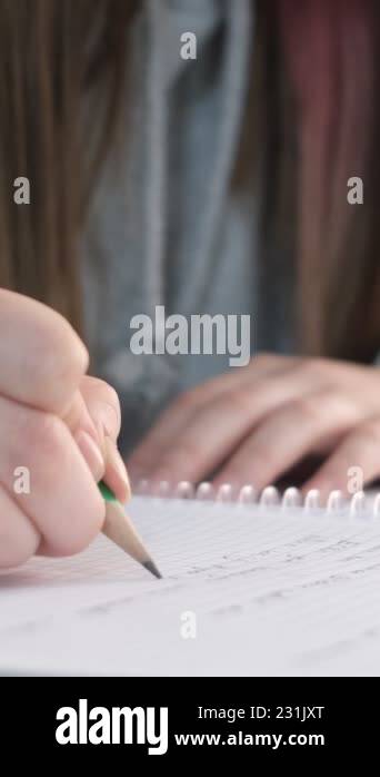 Taking notes in the notebook with colored pencils, writing with pencil ...
