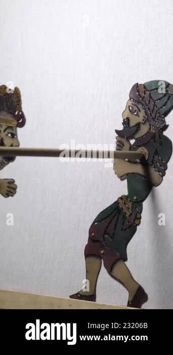 Traditional theater with a pair of puppets playing behind the scenes ...