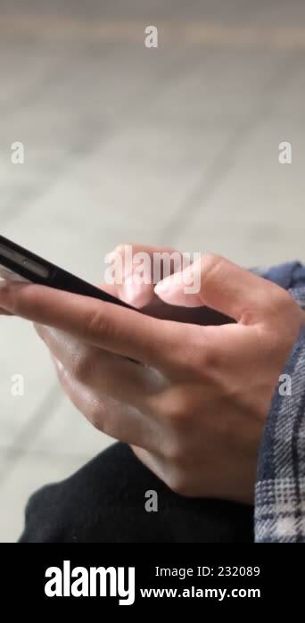 The images of texting on the phone in hand, typing very quickly by ...