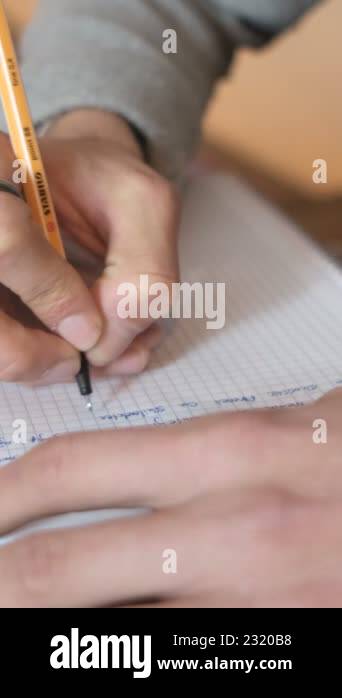 Young man taking notes with colored pencils, taking notes highlighters ...