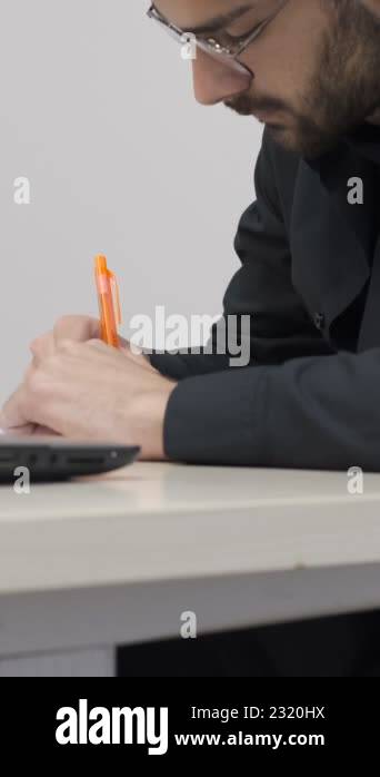 Man Study Homework, hardworking student studying, taking notes with pen ...