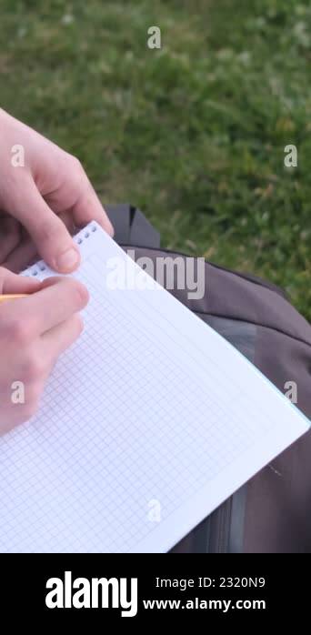 Writing activity on paper on the grass, working environment outside on ...