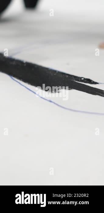 Painting canvas with slow motion brush strokes, painting black with a ...