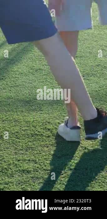 Two young men are dribbling each other with the ball on the carpet ...