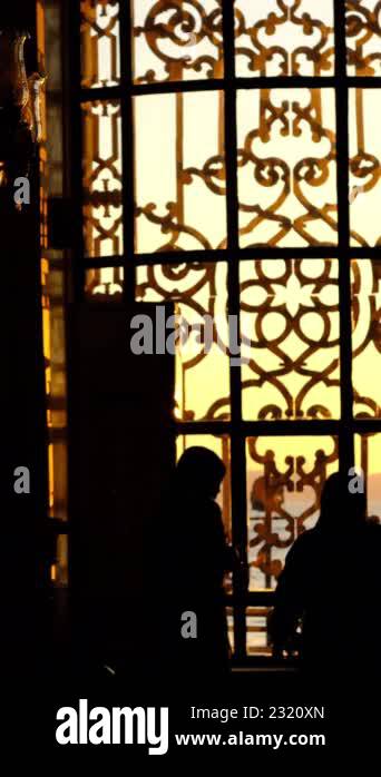 Silhouettes of people inside the mosque from the window, the shadows of ...