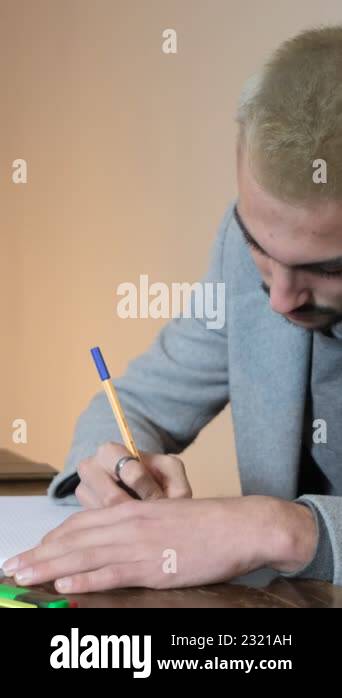 Young man taking notes with colored pencils, taking notes highlighters ...