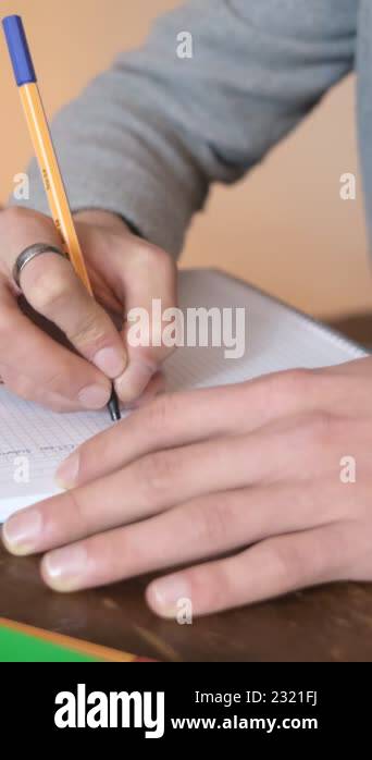 Young man taking notes with colored pencils, taking notes highlighters ...