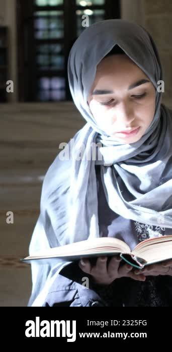 Young Muslim woman reading quran, reciting quran, woman praying in ...