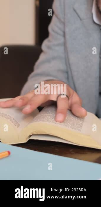 Concept of young man carefully reading a book with his back to the ...