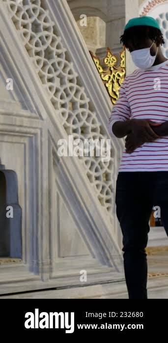 African black young man prays in the mosque , young man with a mask on ...