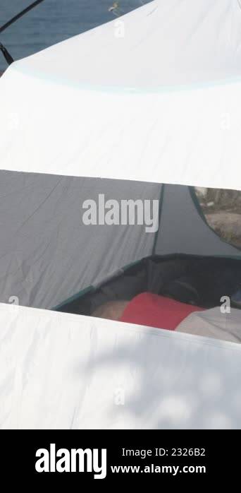 Man waking up in tent, view of young camper waking up in tent, male ...