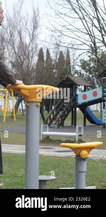 Turning waist stretching movement, doing sports on public sports ...