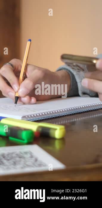 Young man taking notes with colored pencils, taking notes highlighters ...