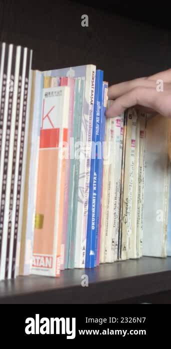 Image with the concept of selecting a book from the library, picking up ...