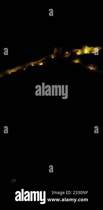 Illuminated castle walls, night drone view of illuminated castle walls ...