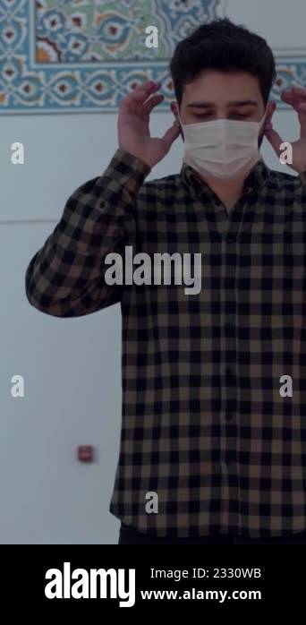 Young masked due to the pandemic is praying, Muslim young man who ...