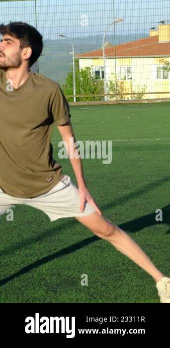 Front view of young man doing warm-up on carpet, athlete teenager doing ...