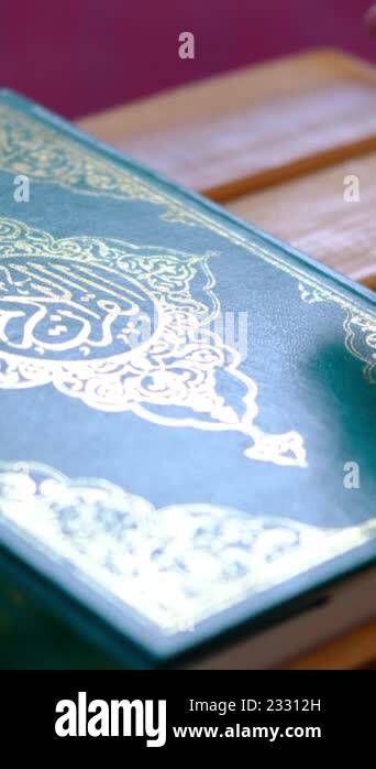 Close-up view of opening the cover of the quran standing on the table ...