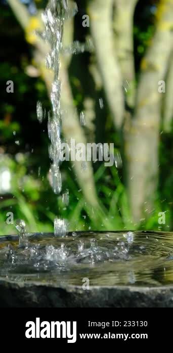 Close up view of hand washing at old fountain standing in park, people ...